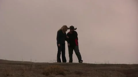 Man and woman goofing off on the horizon... | Stock Video | Pond5