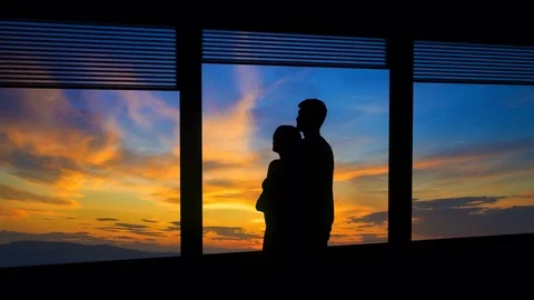 The man and woman hug near the window on... | Stock Video | Pond5