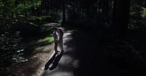 Man and woman stand in forest road holdi... | Stock Video | Pond5
