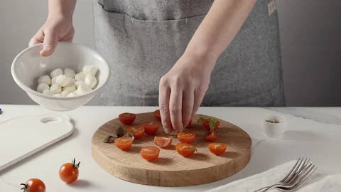 A man in an apron puts mozzarella balls ... | Stock Video | Pond5