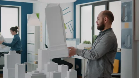 Man architect analyzing building model a... | Stock Video | Pond5