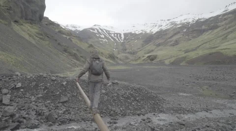 Man Balances Across Pipe Hiking Across B... | Stock Video | Pond5