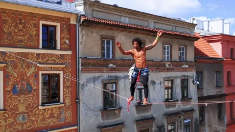 man balances on tight rope, a view of th... | Stock Video | Pond5