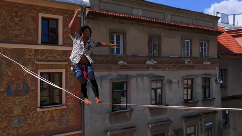 man balances on tight rope, a view of th... | Stock Video | Pond5