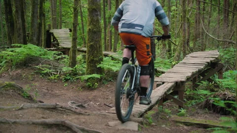 Man Balancing Skinny Wood Ramp in Forest... | Stock Video | Pond5