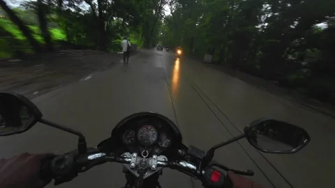 man bike ride in rain at aarey coleny in... | Stock Video | Pond5