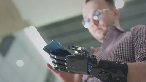 Man with a bionic futuristic arm uses sm... | Stock Video | Pond5