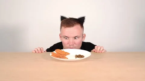 Man in black cat ear hoop appears from u... | Stock Video | Pond5