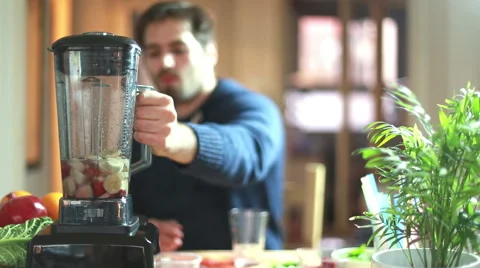 Man blending fruits in blender | Stock Video | Pond5