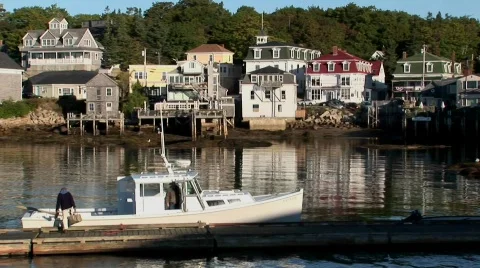 A man boards a small ship that leaves a ... | Stock Video | Pond5