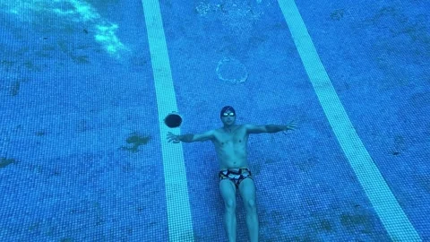 A man at the bottom of a blue pool relea... | Stock Video | Pond5
