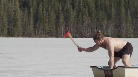 Man Breaking Ice On Frozen Lake With Axe... | Stock Video | Pond5
