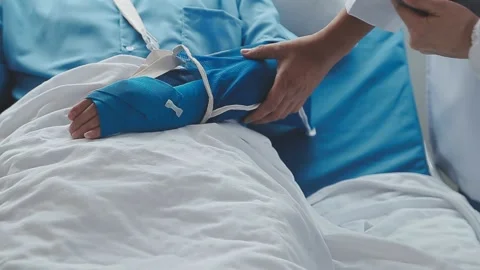 Man with broken arm in cast lying on bed... | Stock Video | Pond5