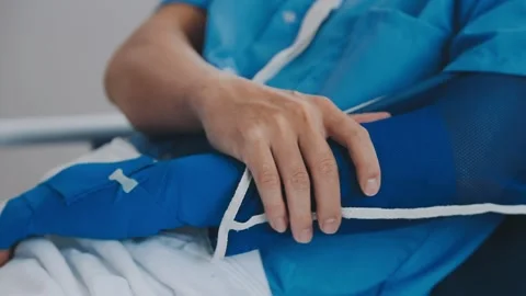Man with broken arm in cast lying on bed... | Stock Video | Pond5