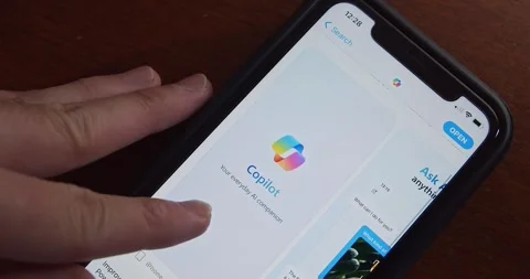 Man browses Microsoft Copilot app in App... | Stock Video | Pond5