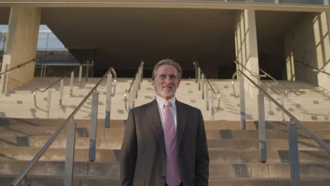 Man In Business Suit Stands On Stairs | Stock Video | Pond5