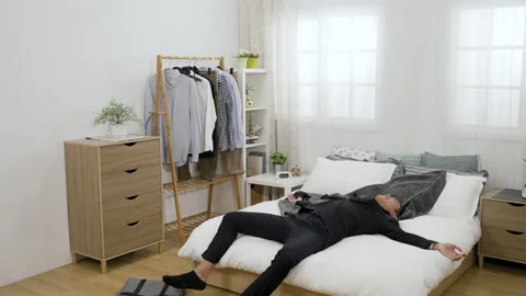 man in business wear is lying sprawl on ... | Stock Video | Pond5