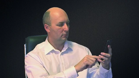 Man calling on dark cell background. | Stock Video | Pond5