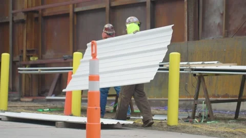 Man Carrying Metal Sheet | Stock Video | Pond5
