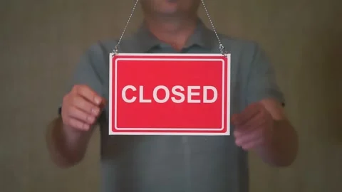 Man changes the closed sign for the open... | Stock Video | Pond5