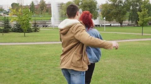 man chasing a woman in a city park | Stock Video | Pond5