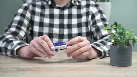 A man checking oxygen level at home with... | Stock Video | Pond5