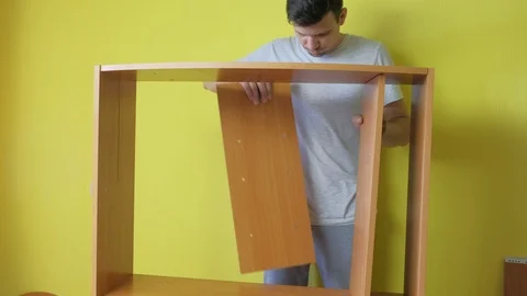 Man is collecting parts of computer tabl... | Stock Video | Pond5