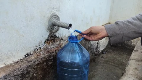 A man collects clean drinking water from... | Stock Video | Pond5