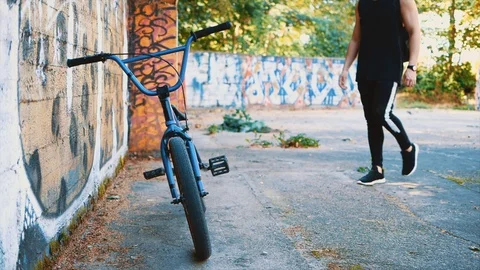 Man is coming closer to the BMX bike in ... | Stock Video | Pond5