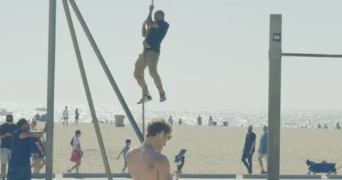 Man coming down from rope in Muscle Beac... | Stock Video | Pond5