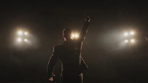 The man is coming on stage and raising u... | Stock Video | Pond5