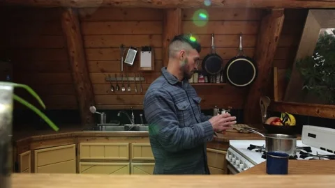 Man cooking in cabin kitchen | Stock Video | Pond5