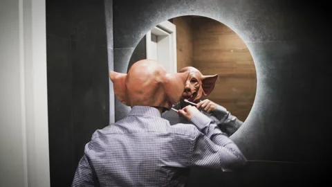 Man with creepy pig mask brushing teeth ... | Stock Video | Pond5