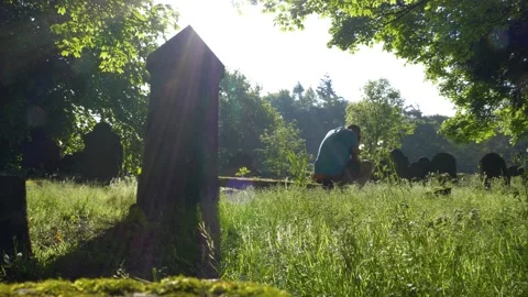 Man Crying At The Graveyard Under The Su... | Stock Video | Pond5
