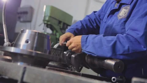 A man cuts a screw thread in a metal par... | Stock Video | Pond5