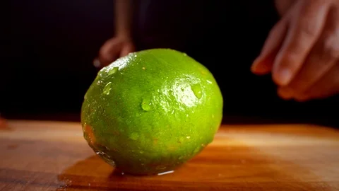 Man cutting a Lime with a sharp knife, p... | Stock Video | Pond5