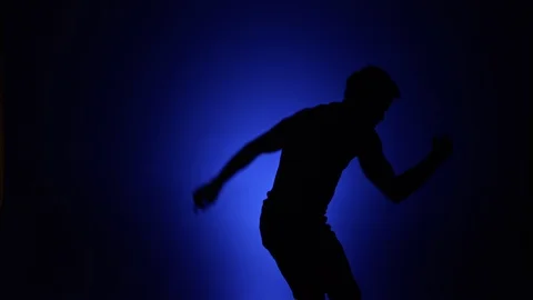 man dancing silhouette blue background 1 | Stock Video | Pond5
