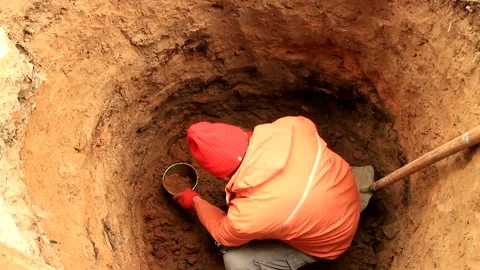 man digger inside the well digging the e... | Stock Video | Pond5