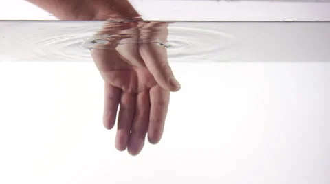 Man dipping his hand slowly into the wat... | Stock Video | Pond5