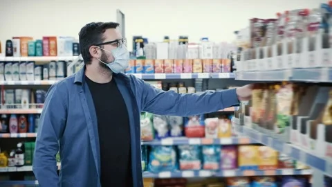 man in disposable mask with cart takes s... | Stock Video | Pond5