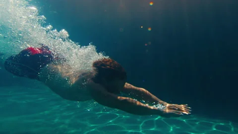 Man dives in the pool. Underwater view o... | Stock Video | Pond5