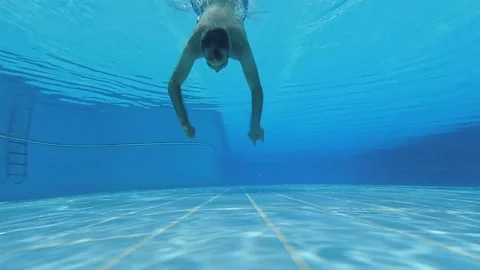 Man diving and swimming underwater in po... | Stock Video | Pond5