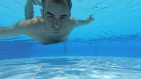 Man diving and swimming underwater in po... | Stock Video | Pond5