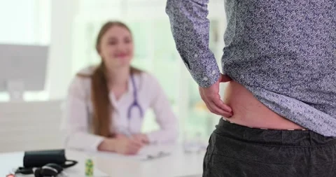 Man in doctor office shows fat folds on ... | Stock Video | Pond5
