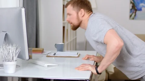 Man Doing Table Push Ups and Watching Wo... | Stock Video | Pond5
