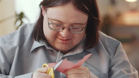 Man with Down Syndrome Doing Paper Craft... | Stock Video | Pond5