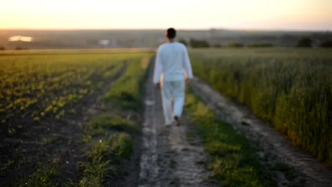 A man dressed in white out of focus walk... | Stock Video | Pond5