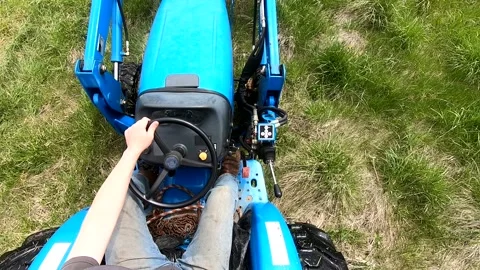 Man Driving A Blue Compact Tractor In Fl... | Stock Video | Pond5