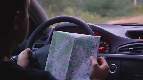 man is driving a car, looking at paper m... | Stock Video | Pond5