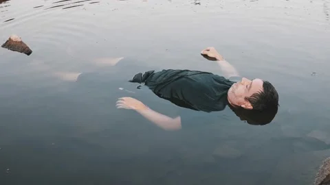 a man drowned , dead in the water , the ... | Stock Video | Pond5